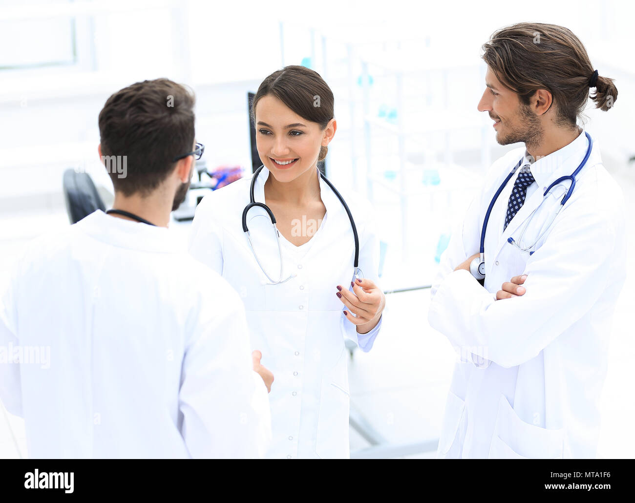 Team of different doctors having conversation Stock Photo - Alamy
