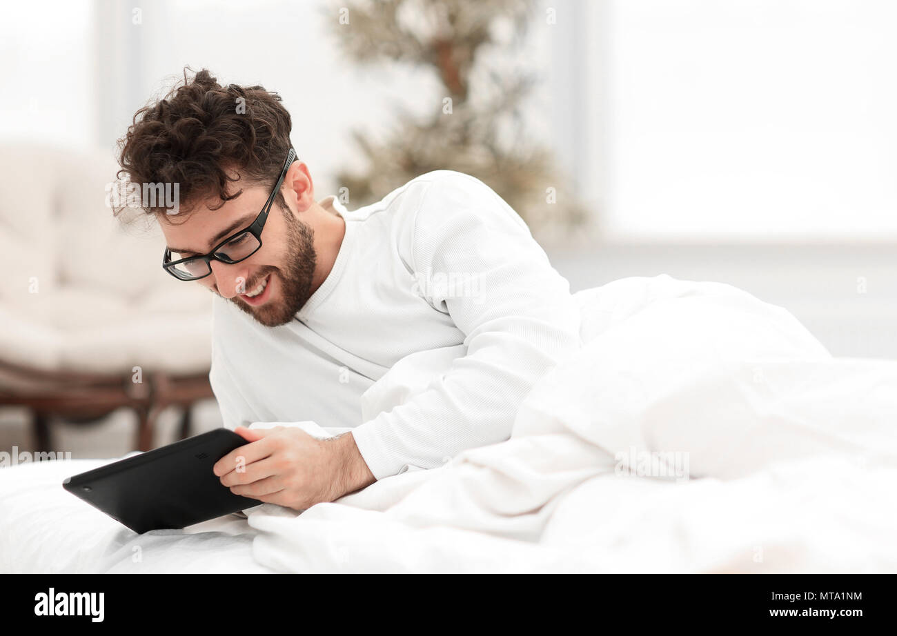 closeup.sleepy man looking at the screen of a digital tablet Stock ...