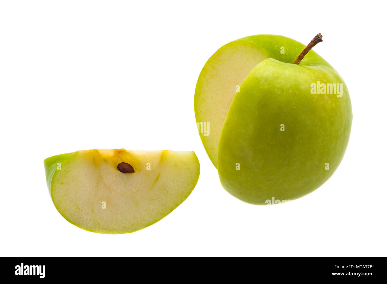 Slice is cut from a large fresh green apple on a white background ...