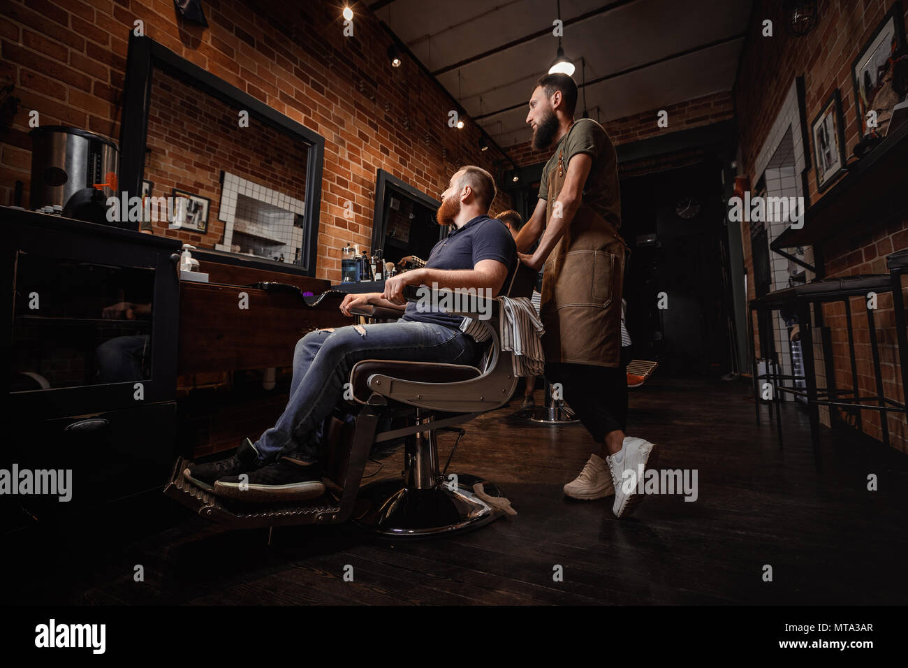 Barber and bearded man in barber shop Stock Photo - Alamy