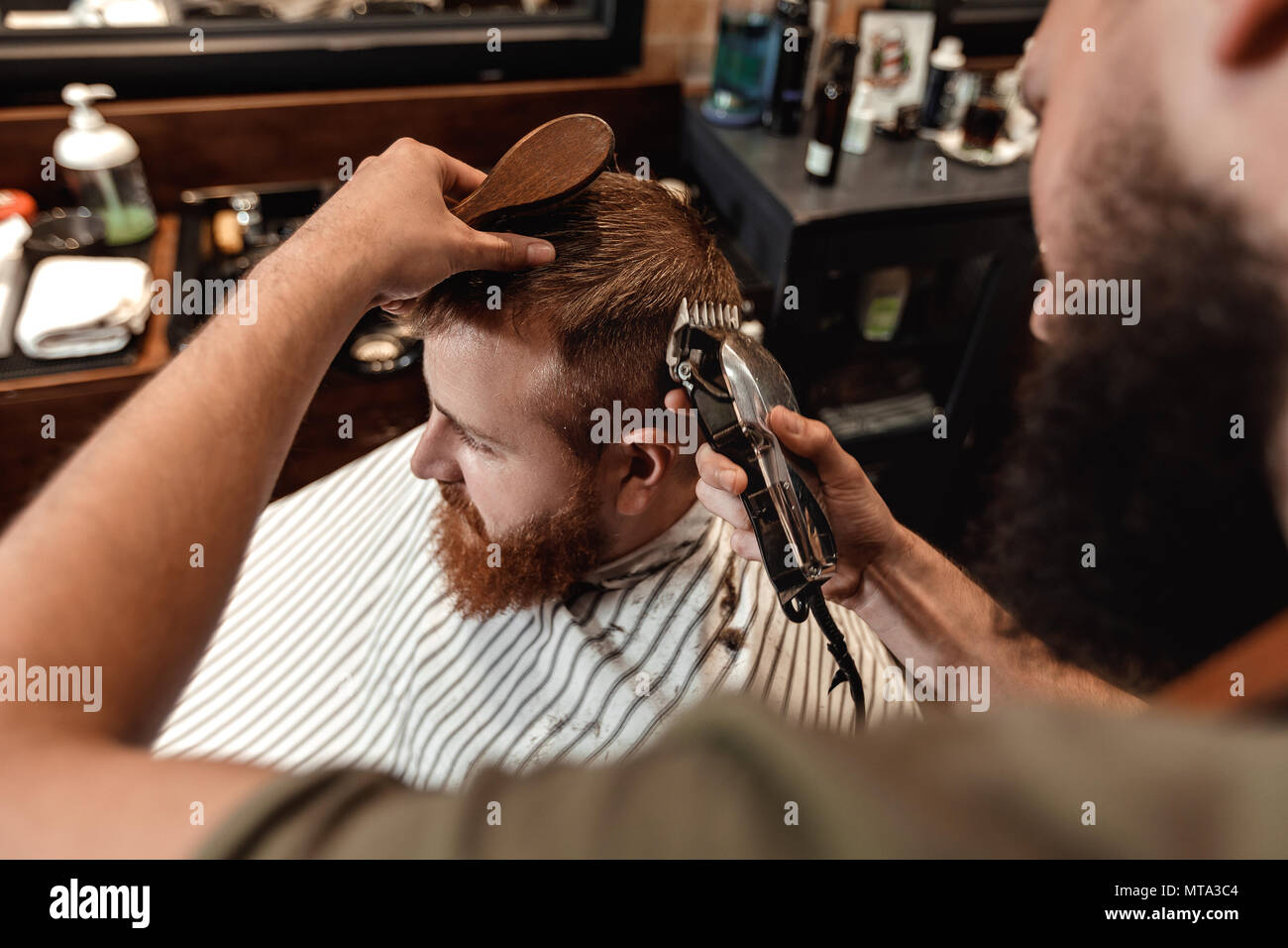 Barber and bearded man in barber shop Stock Photo - Alamy