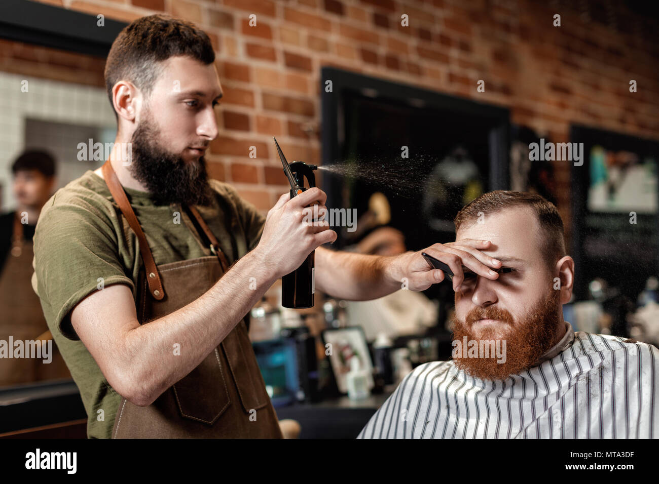 Barber and bearded man in barber shop Stock Photo - Alamy