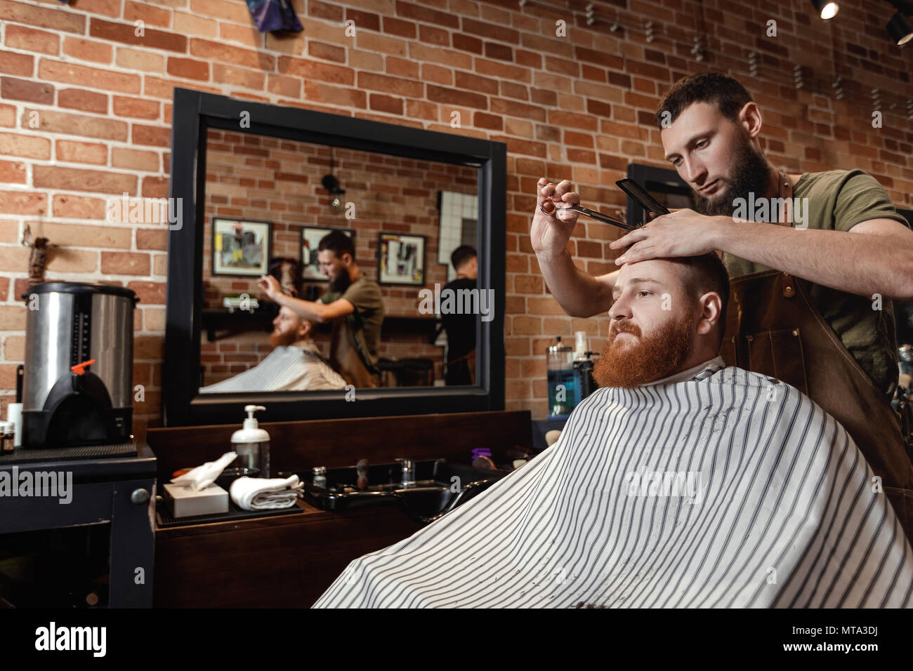 Barber and bearded man in barber shop Stock Photo - Alamy