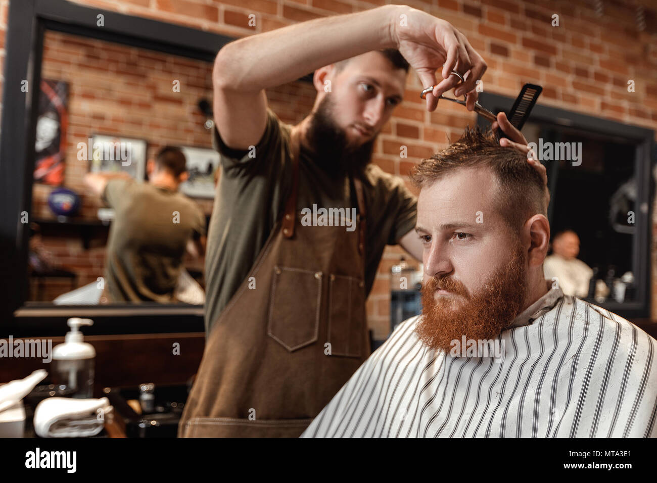 Barber and bearded man in barber shop Stock Photo - Alamy