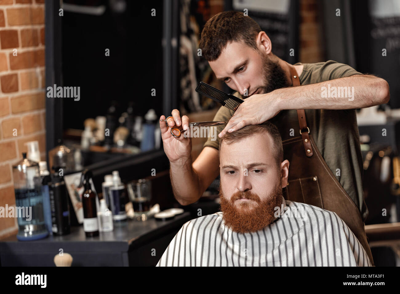 Barber and bearded man in barber shop Stock Photo - Alamy