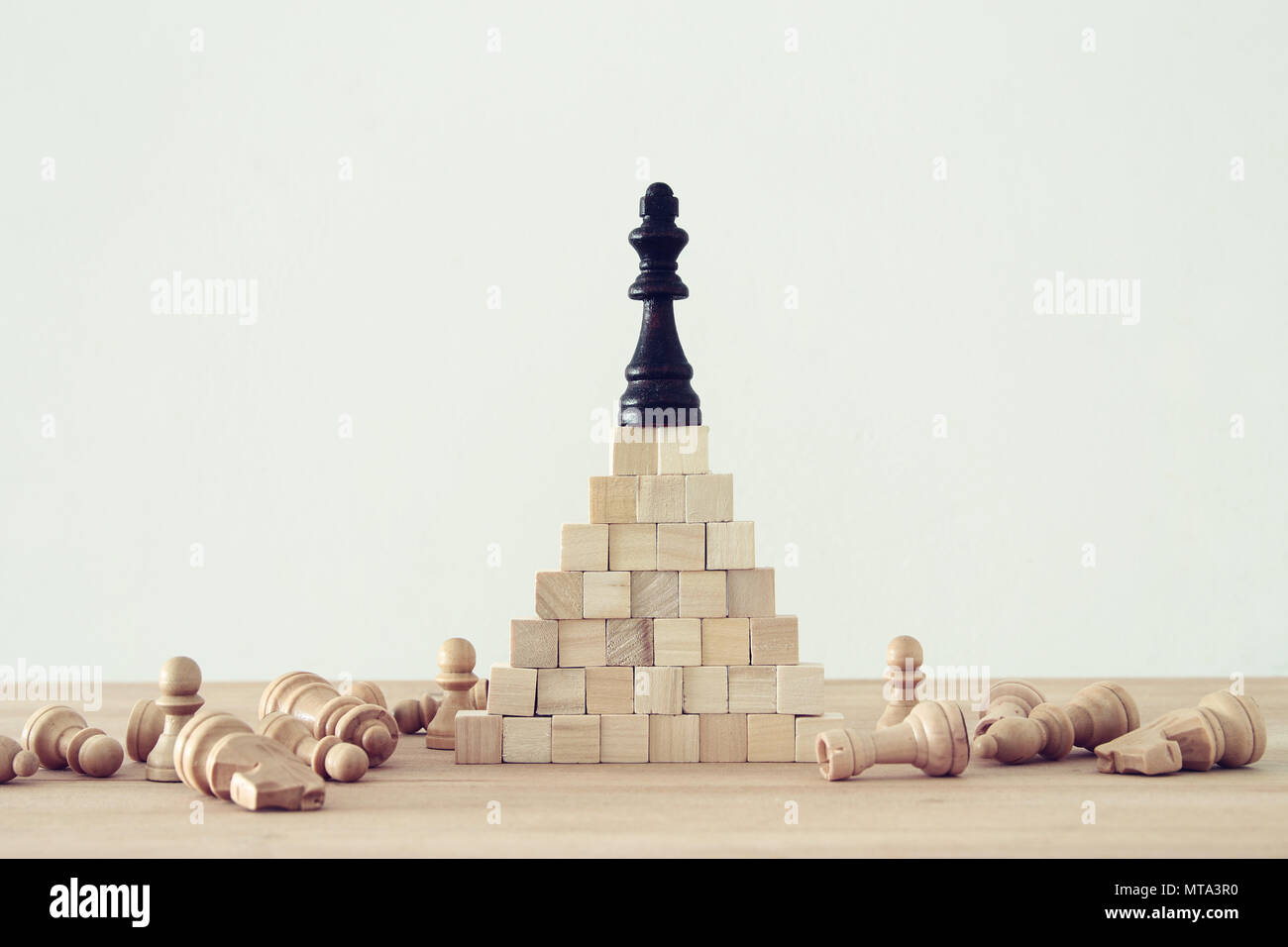 image of chess figure standing on a pyramid top. Business, competition ...