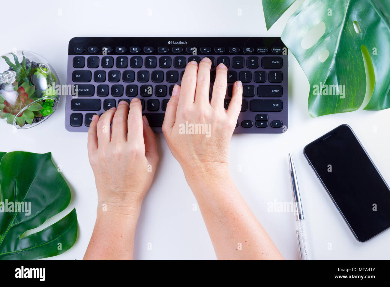 Flat lay home office workspace with someones hands typing on black ...