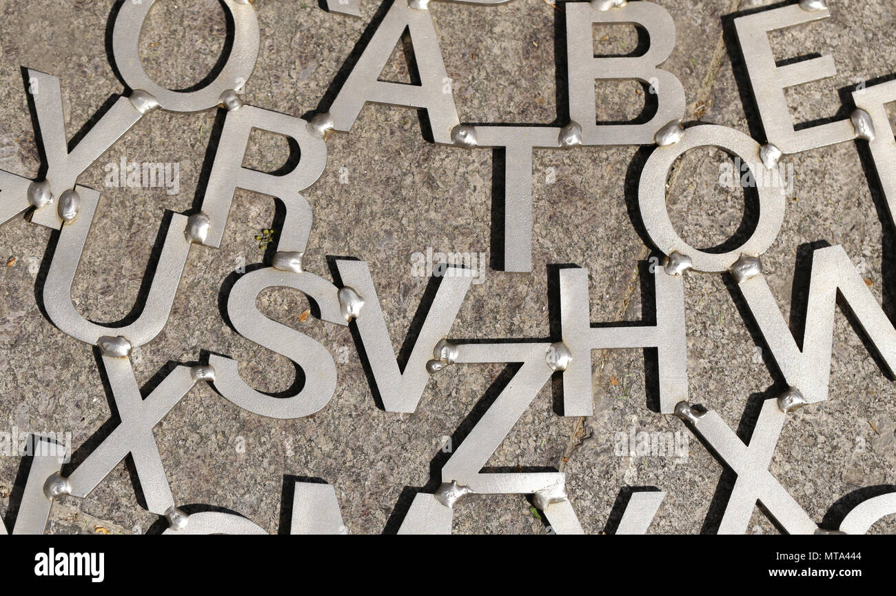 old metal letters on a gray background Stock Photo - Alamy