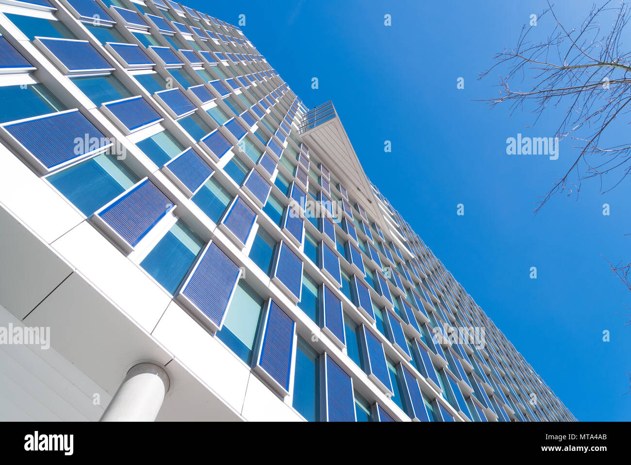 modern eco office building exterior with solar panels on its facade ...