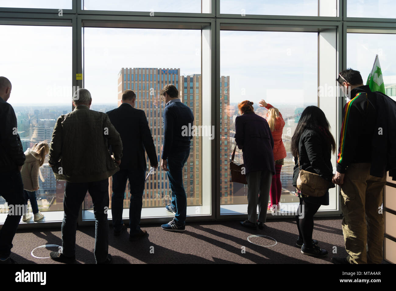 AMSTERDAM, NETHERLANDS - MARCH 25, 2017: Unknown people looking through ...
