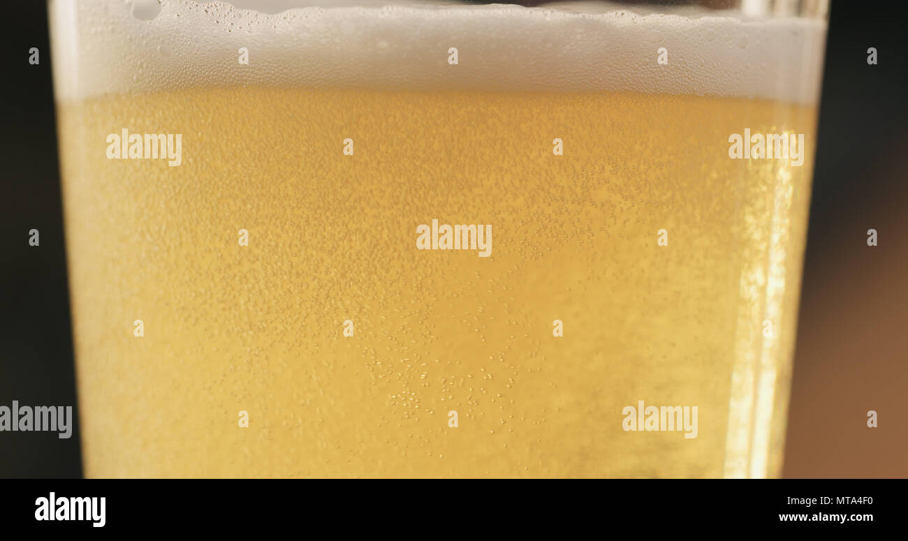 closeup of lager beer pouring in a glass, wide photo Stock Photo - Alamy