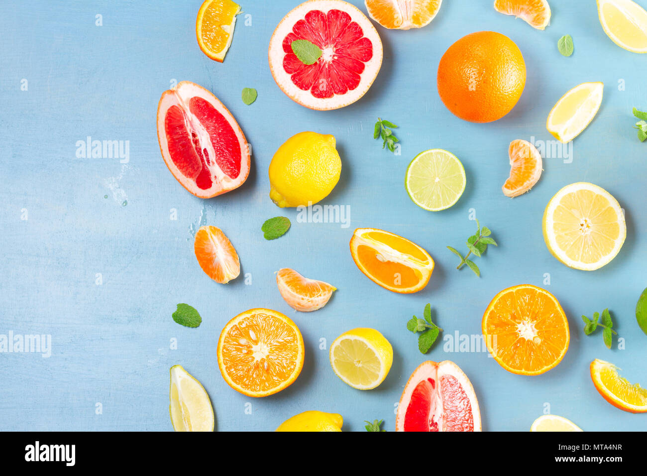 citrus slices food pattern on blue background with copy space ...