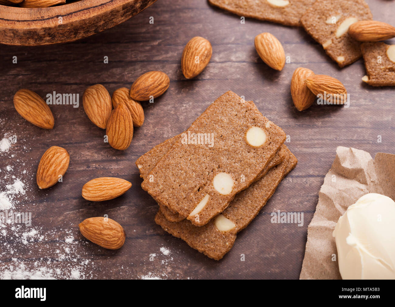 Homemade almond biscuit cookies with raw almonds and butter on wooden ...
