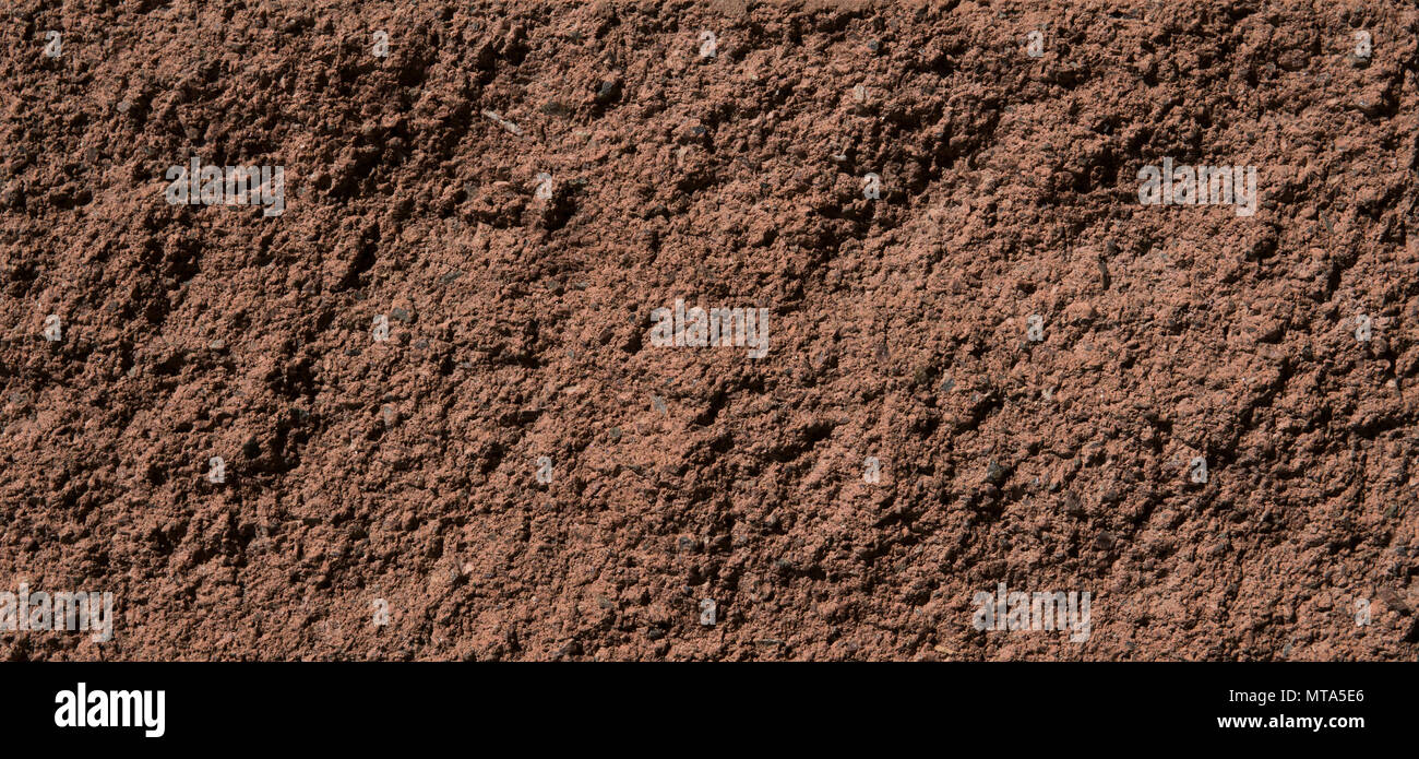 Brown-red walls stone texture lit by bright sunlight Stock Photo - Alamy