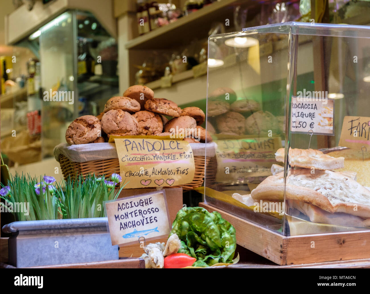 Colorful Italian shop window displaying tempting variety of food items ...