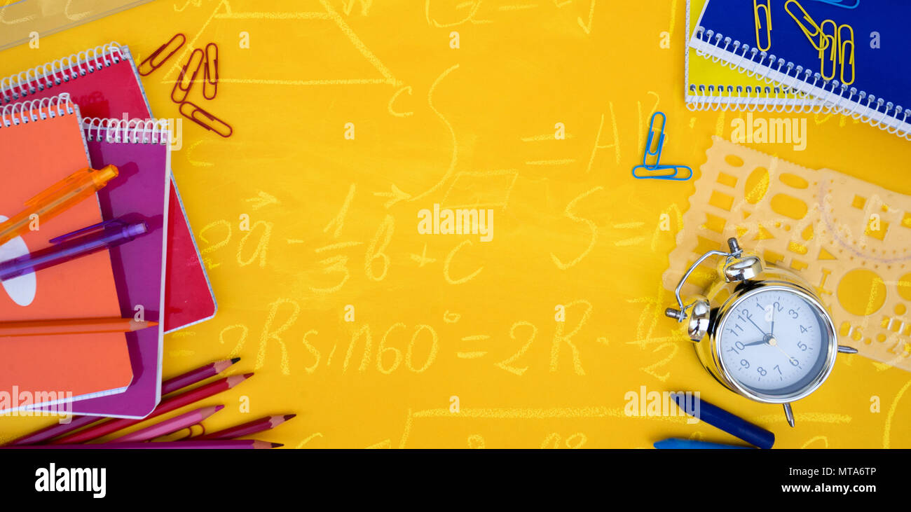 back to school styed scene with school supplies on yellow with math ...