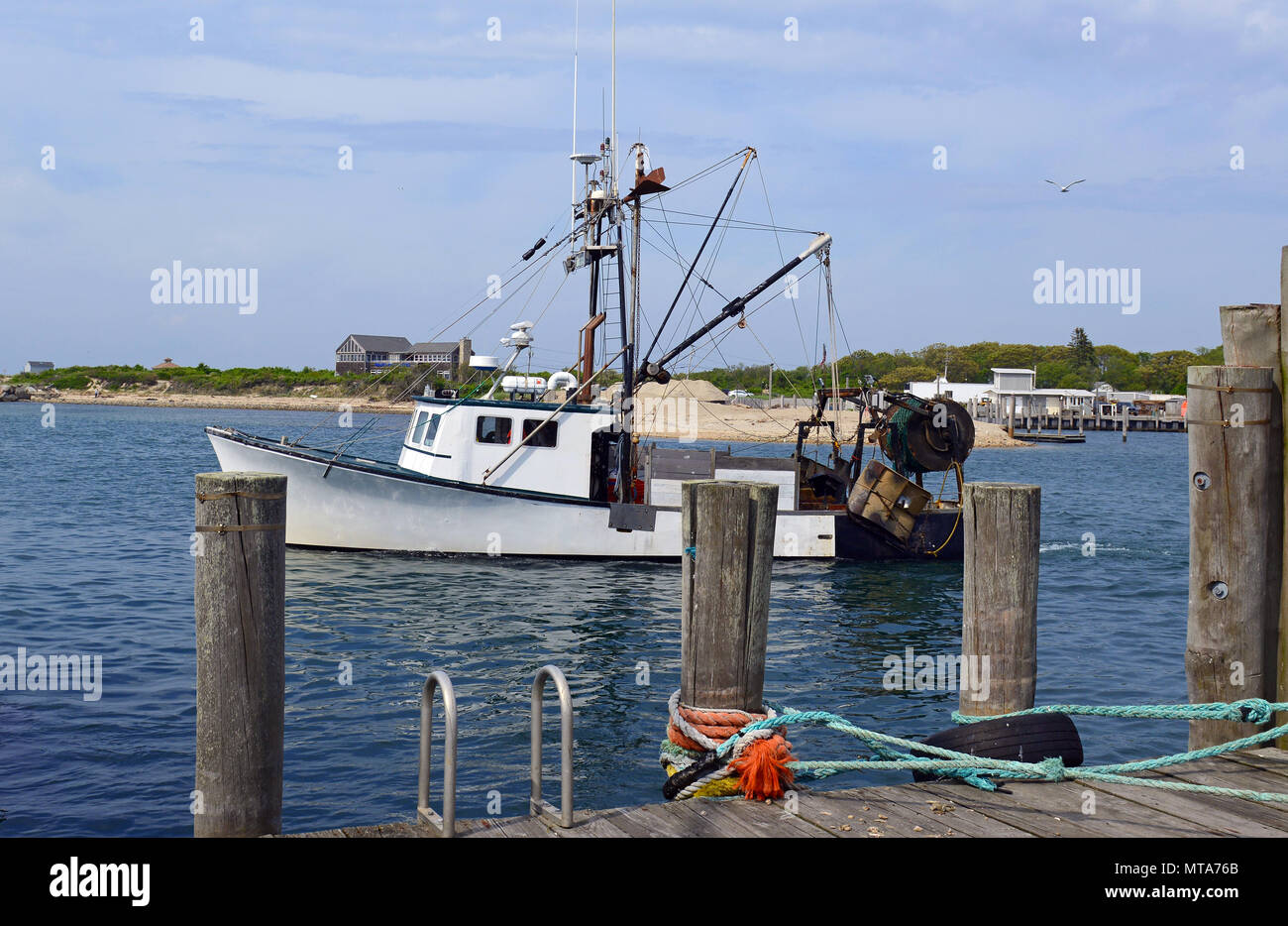 Maritime scene with commercial fishing boats in water near dock Stock ...