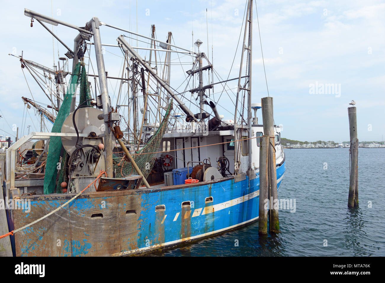 Maritime scene with commercial fishing boats in water near dock Stock ...