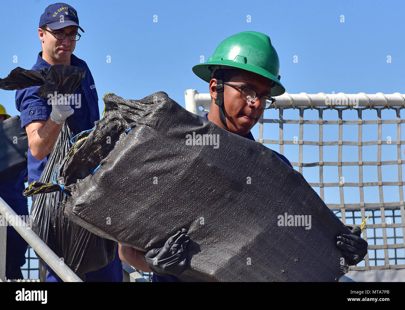 The crew of the Coast Guard Cutter Steadfast offloads contraband during ...