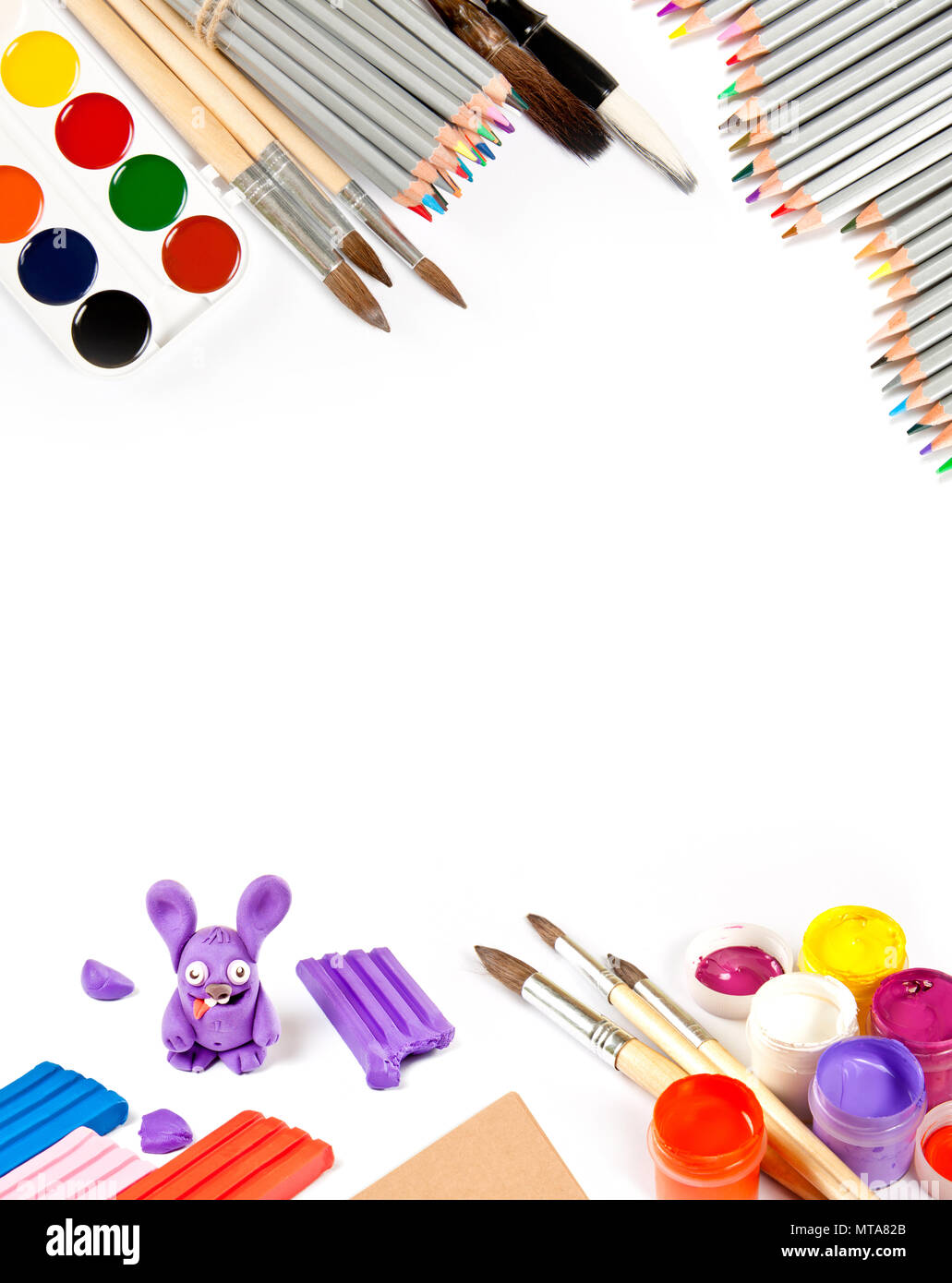Watercolor paint, paint brushes, plasticine and pencils against white ...