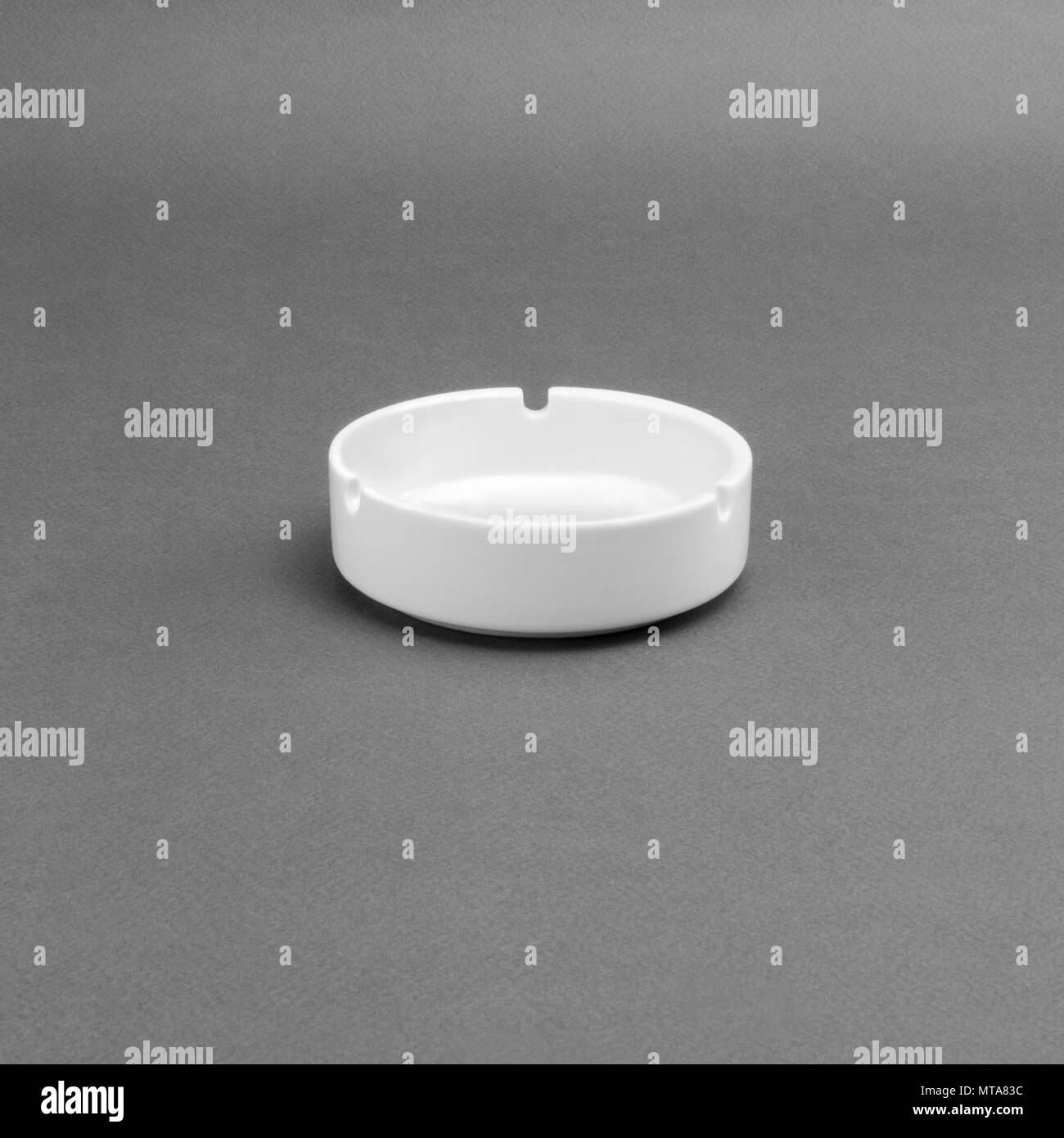 White ceramic ashtray isolated on a gray background Stock Photo - Alamy