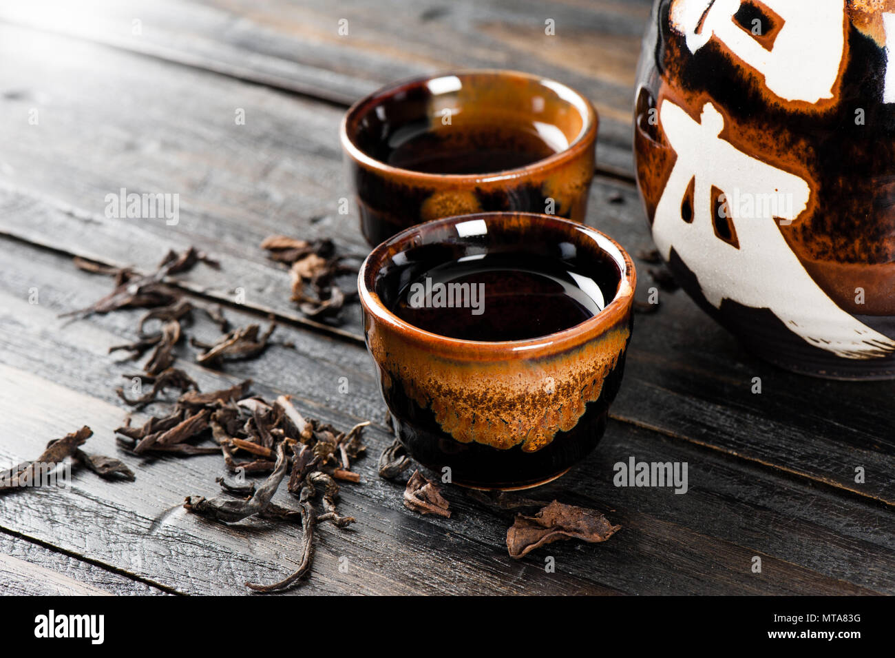 the classic brown japanese tea set on wooden table, with the word ...