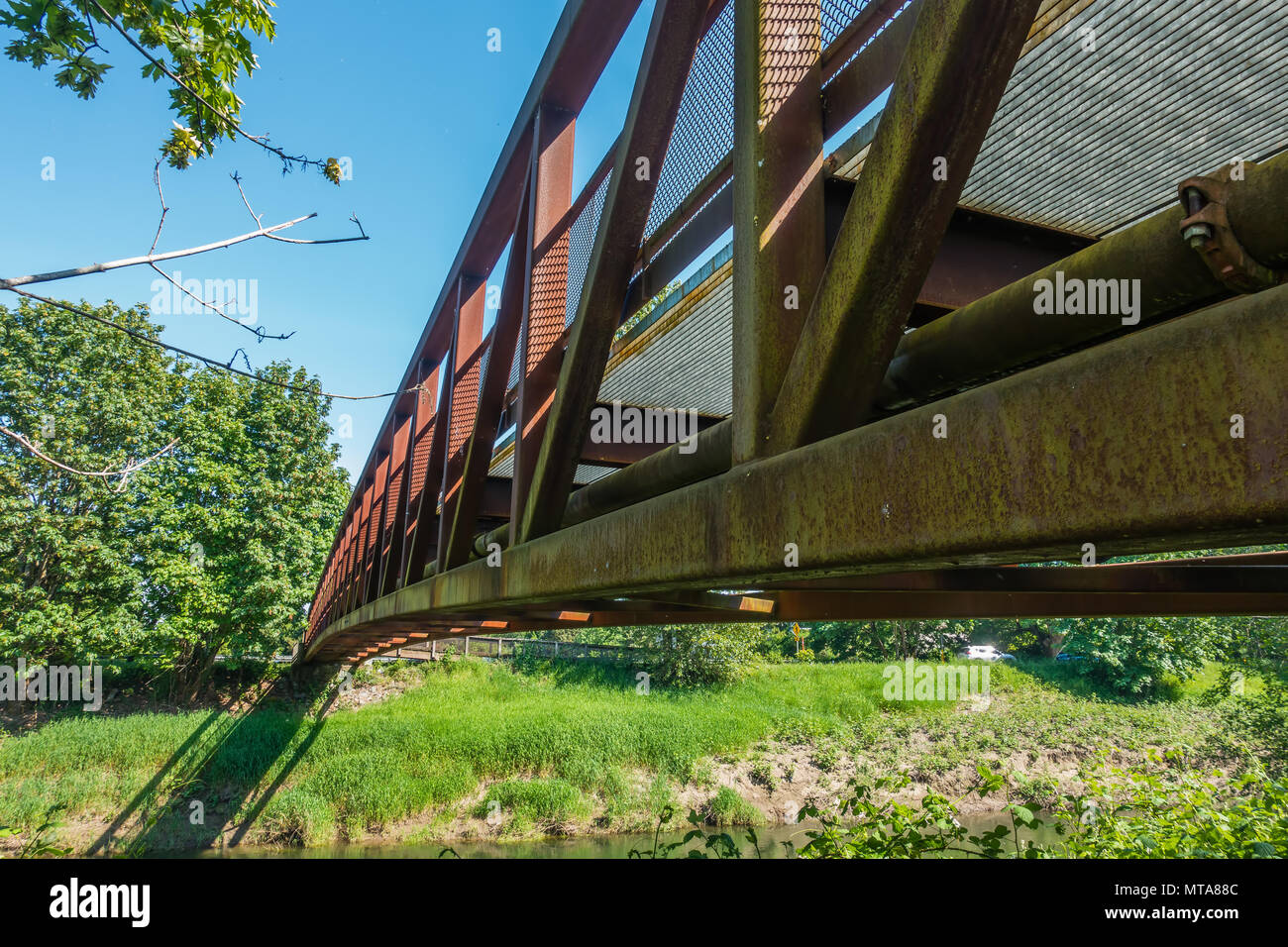 A view from beneath a rusty metal walking bridge that spans the Green ...