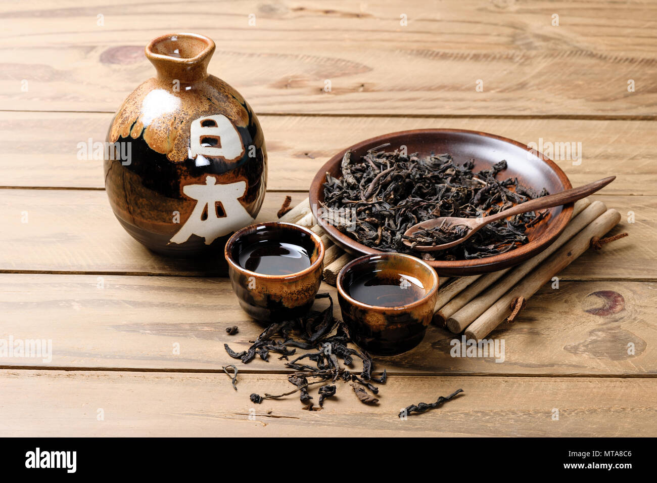 the classic brown japanese tea set on wooden table, with the word ...