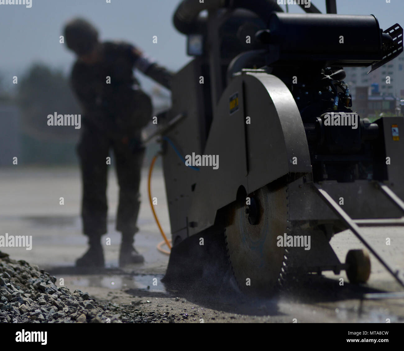 A Republic of Korea Airman cuts concrete during the U.S./ROK Combined ...