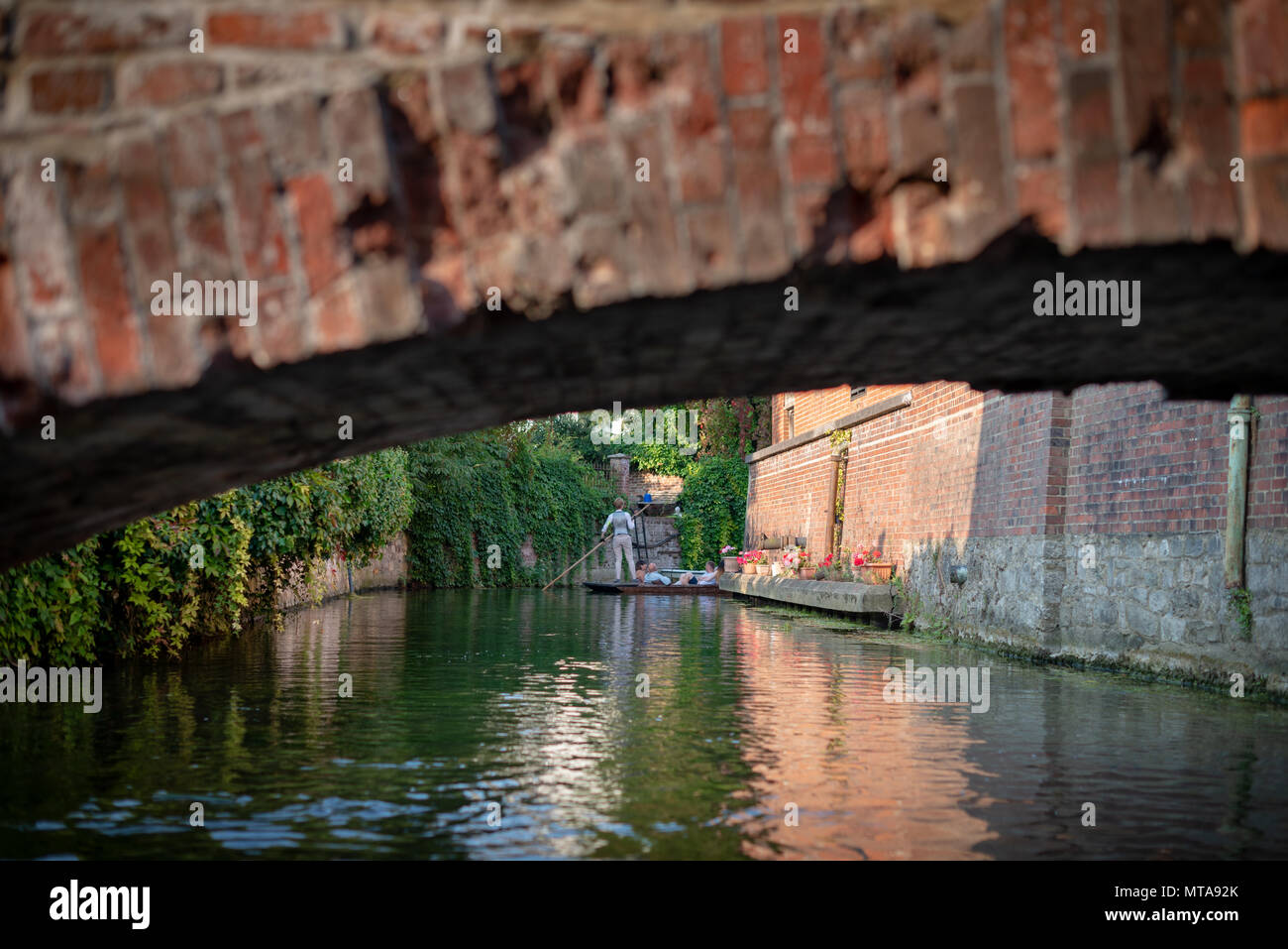 Tourists on a river punt trip on the Great Stour river at Canterbury ...