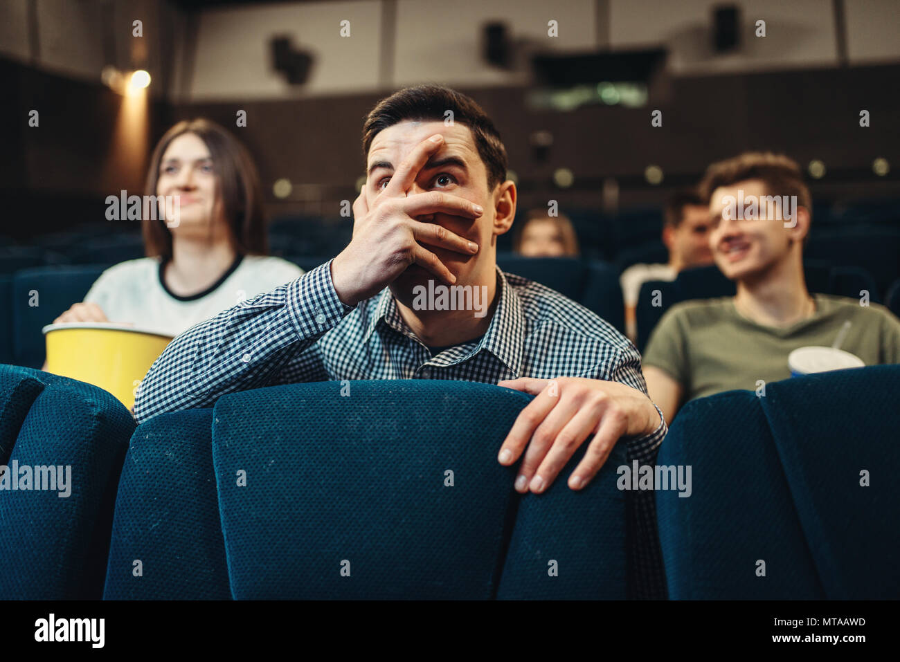 Scared man watching movie in cinema. Showtime, entertainment Stock ...