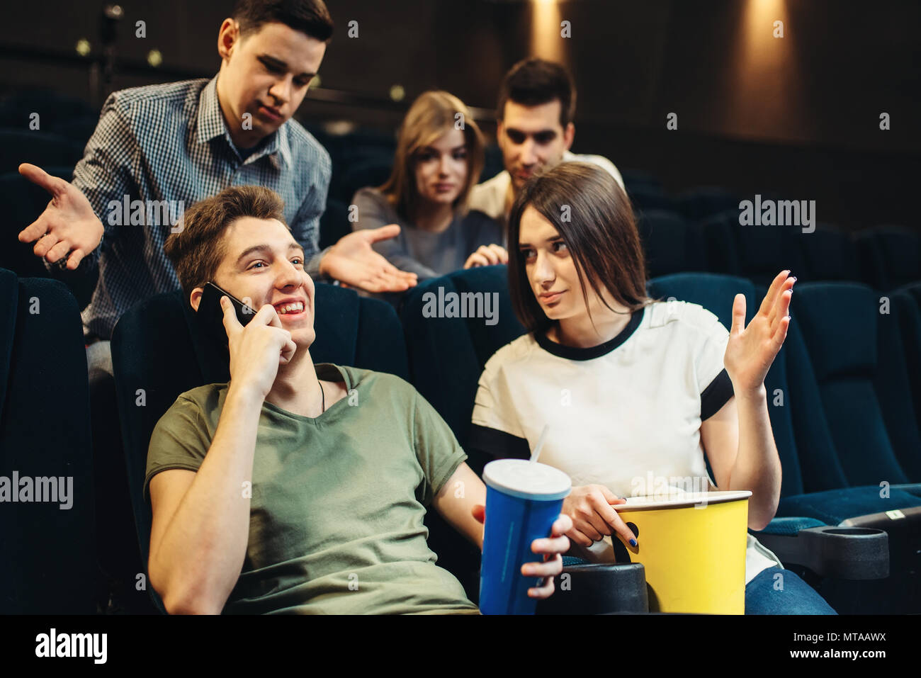 Male friends talking hall hi-res stock photography and images - Alamy