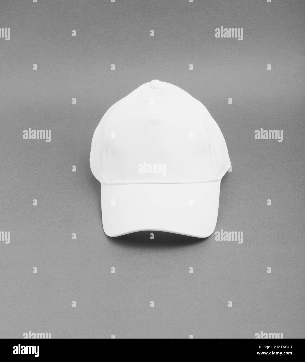White baseball cap on gray background Stock Photo - Alamy