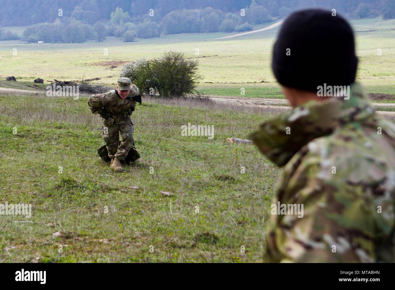 An Infantry Soldier pulls a 250 lbs. litter across a rocky terrain ...