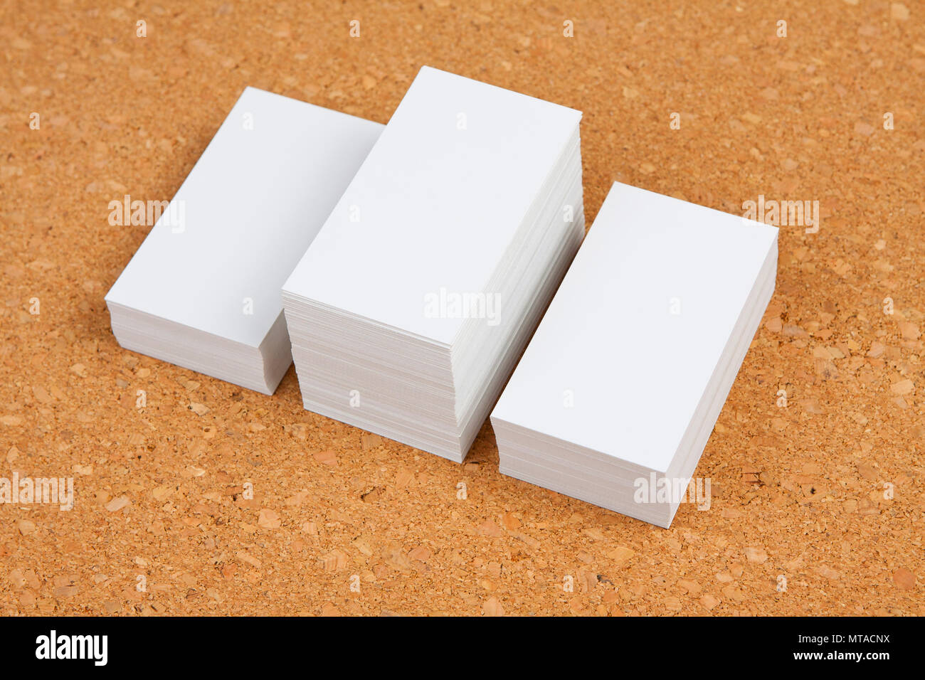 Three piles of business cards on corkboard backgroun Stock Photo - Alamy