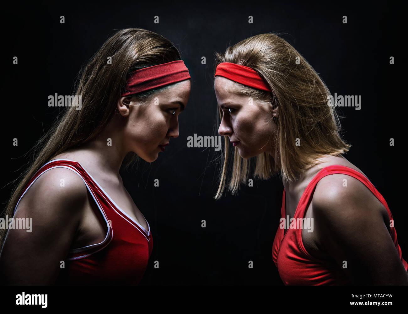 Two female boxers in red sportswear standing face to face. Fighting ...