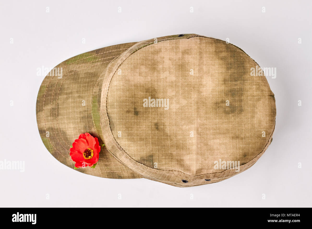 Old military cap with red popper. Top view. White isolated background ...