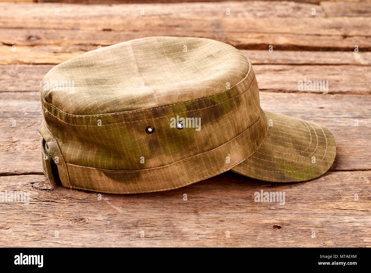 Soldiers cap on wood. Side view. Brown wooden desk surface background ...