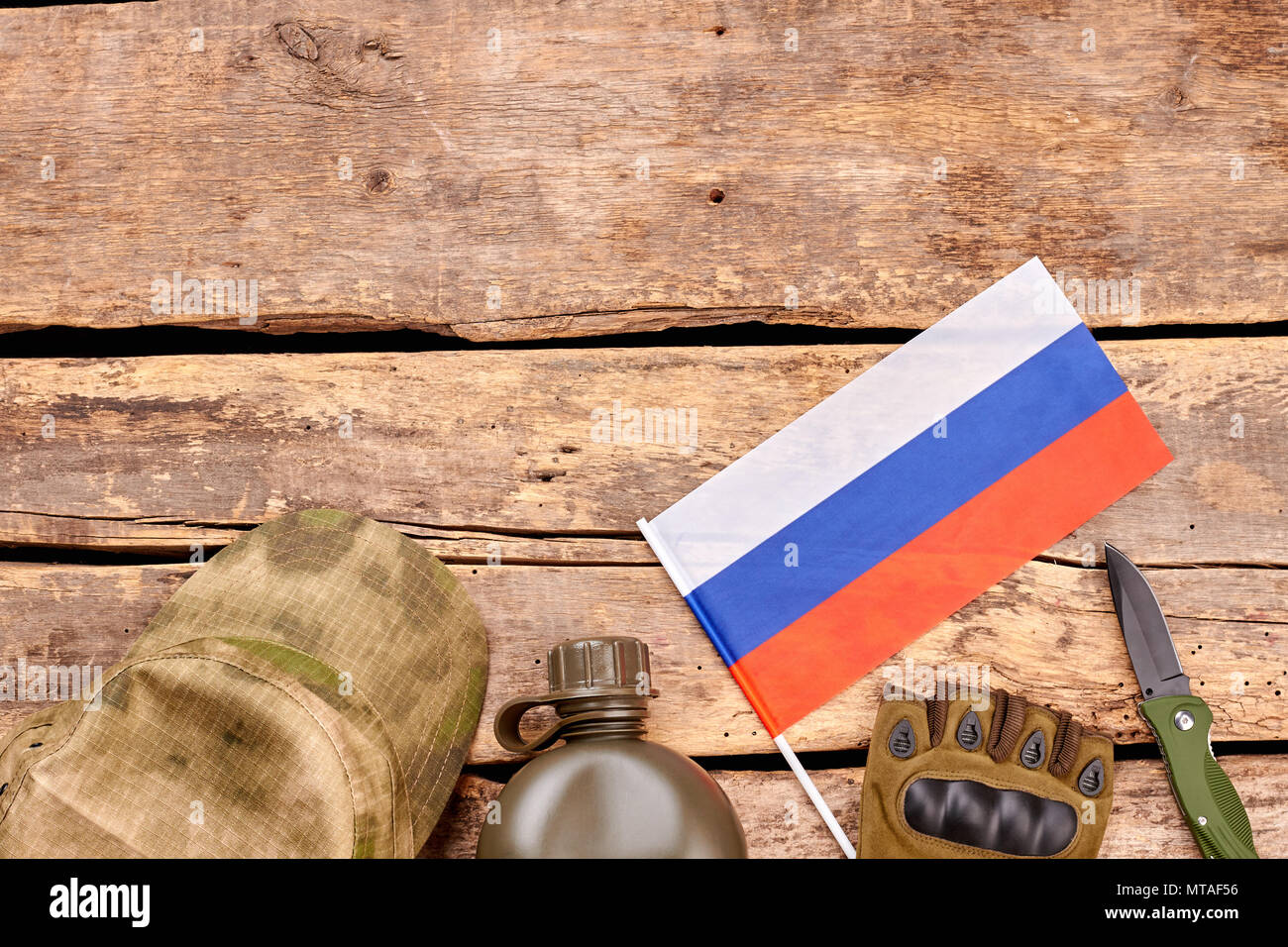 Accessories of russian army soldier. Flat lay, top view. Wooden desk ...