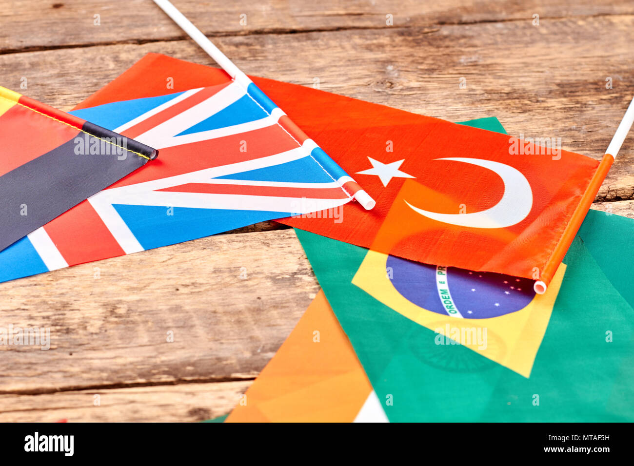 Different country flags on table. CLose up, flags on wood Stock Photo ...
