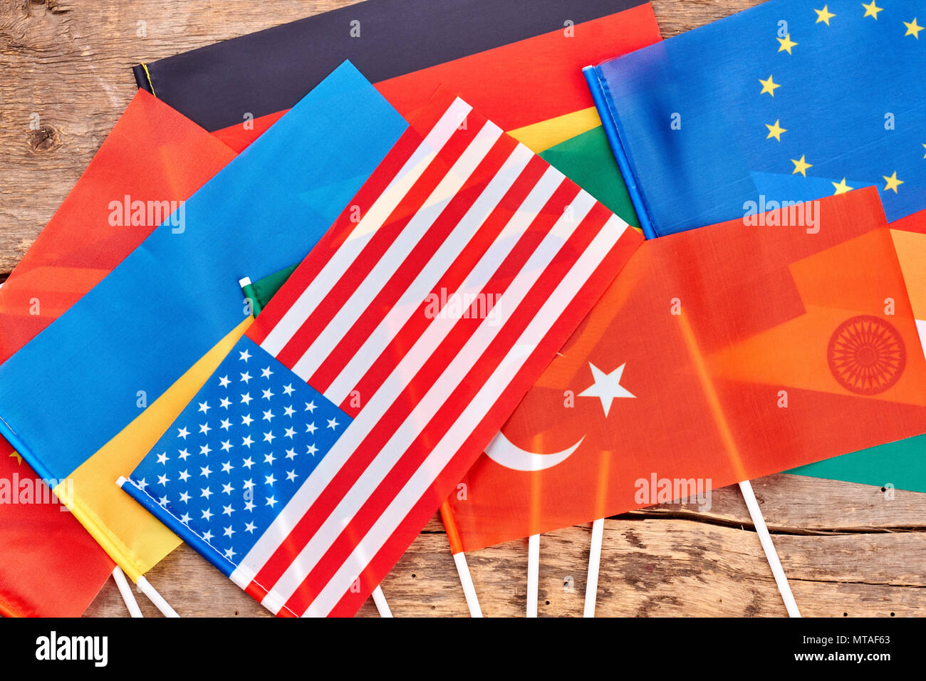 Assemble of flags pile top view. Flat lay. Wooden desk background Stock ...