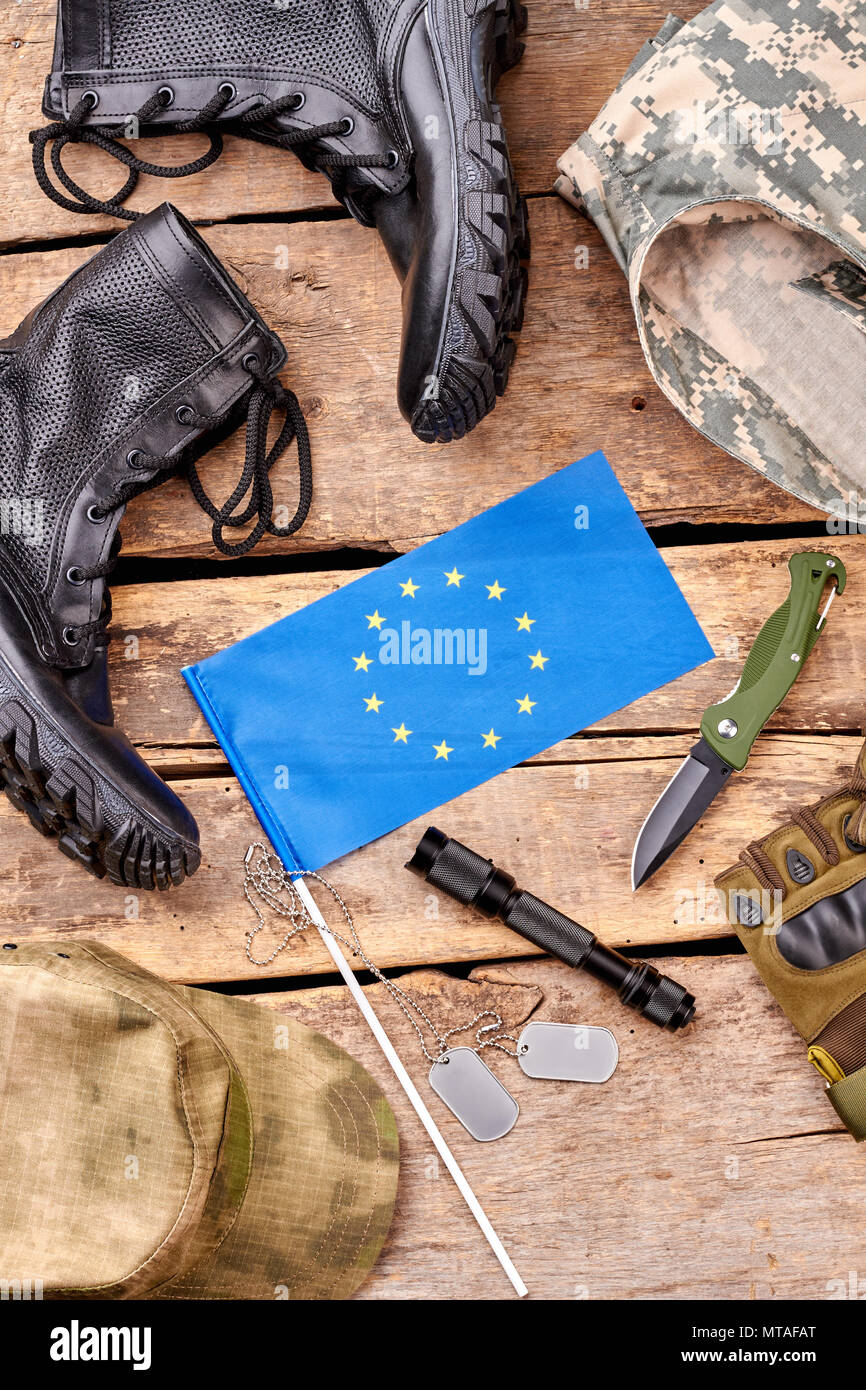 Army uniform and accessories top view. Flat lay. Wooden desk background ...