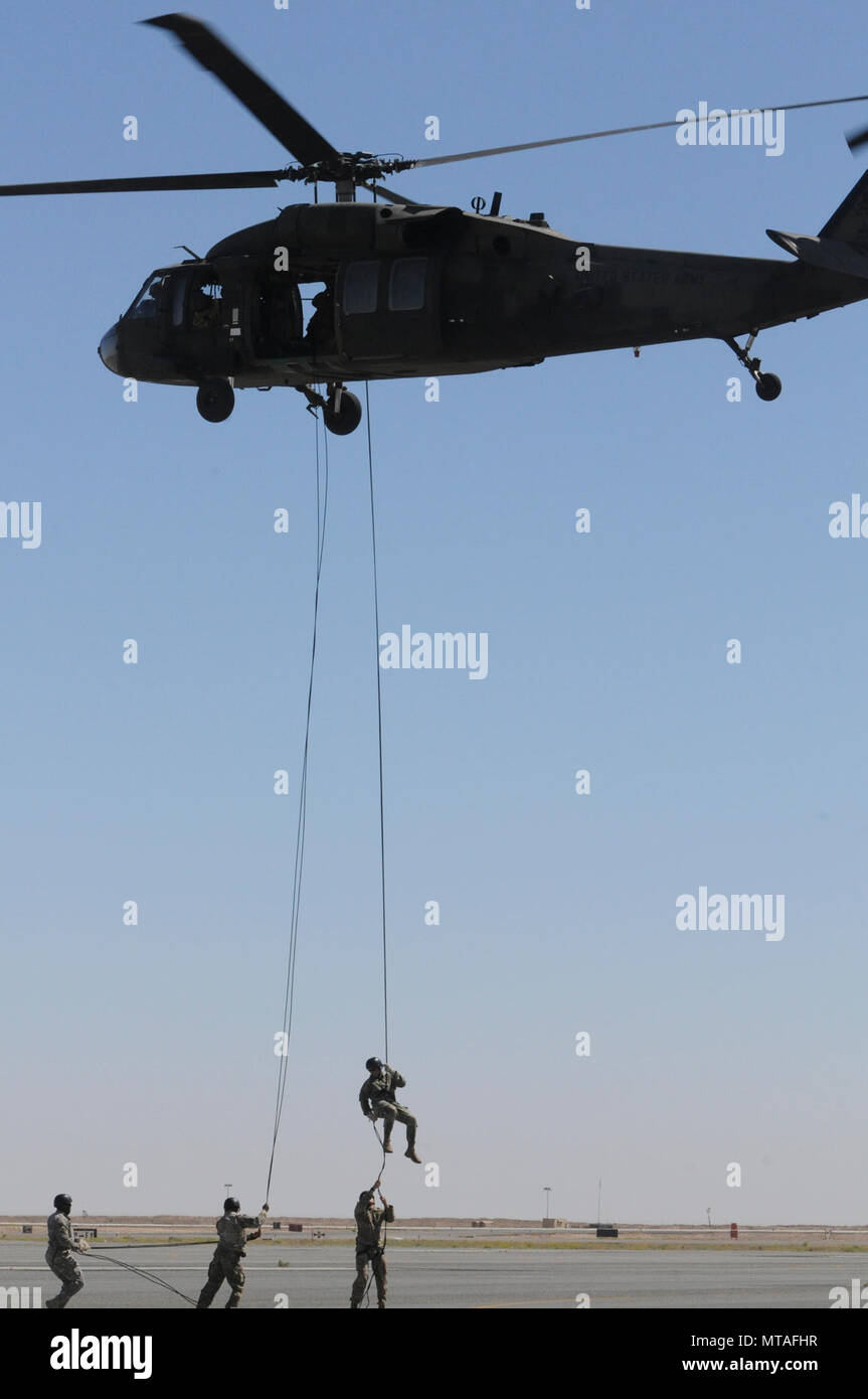 U.S. Army Soldiers rappel out of a UH-60 helicopter on April 20 at Camp ...