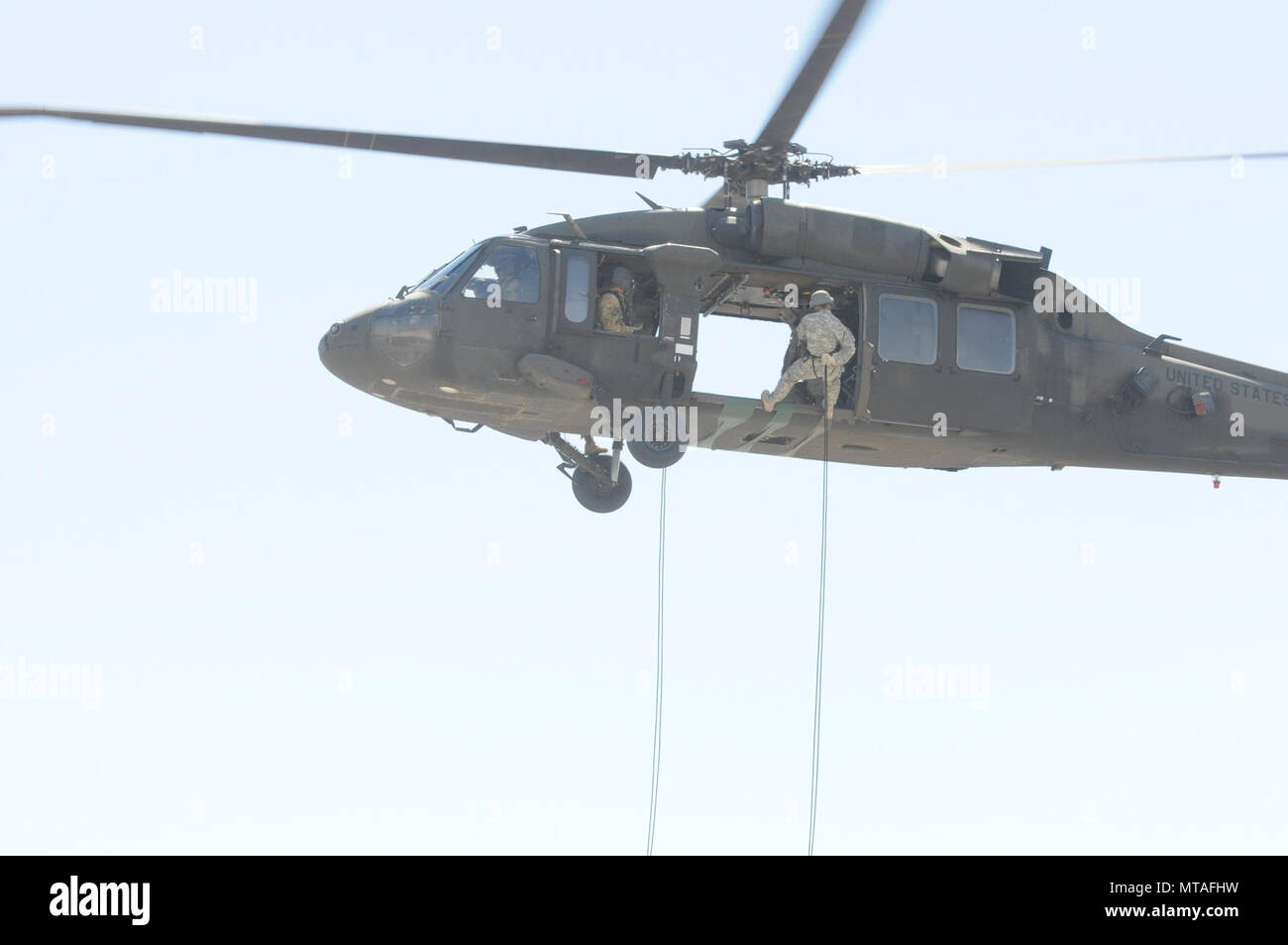 A U.S. Army Soldier prepares to rappel out of a UH-60 helicopter during ...