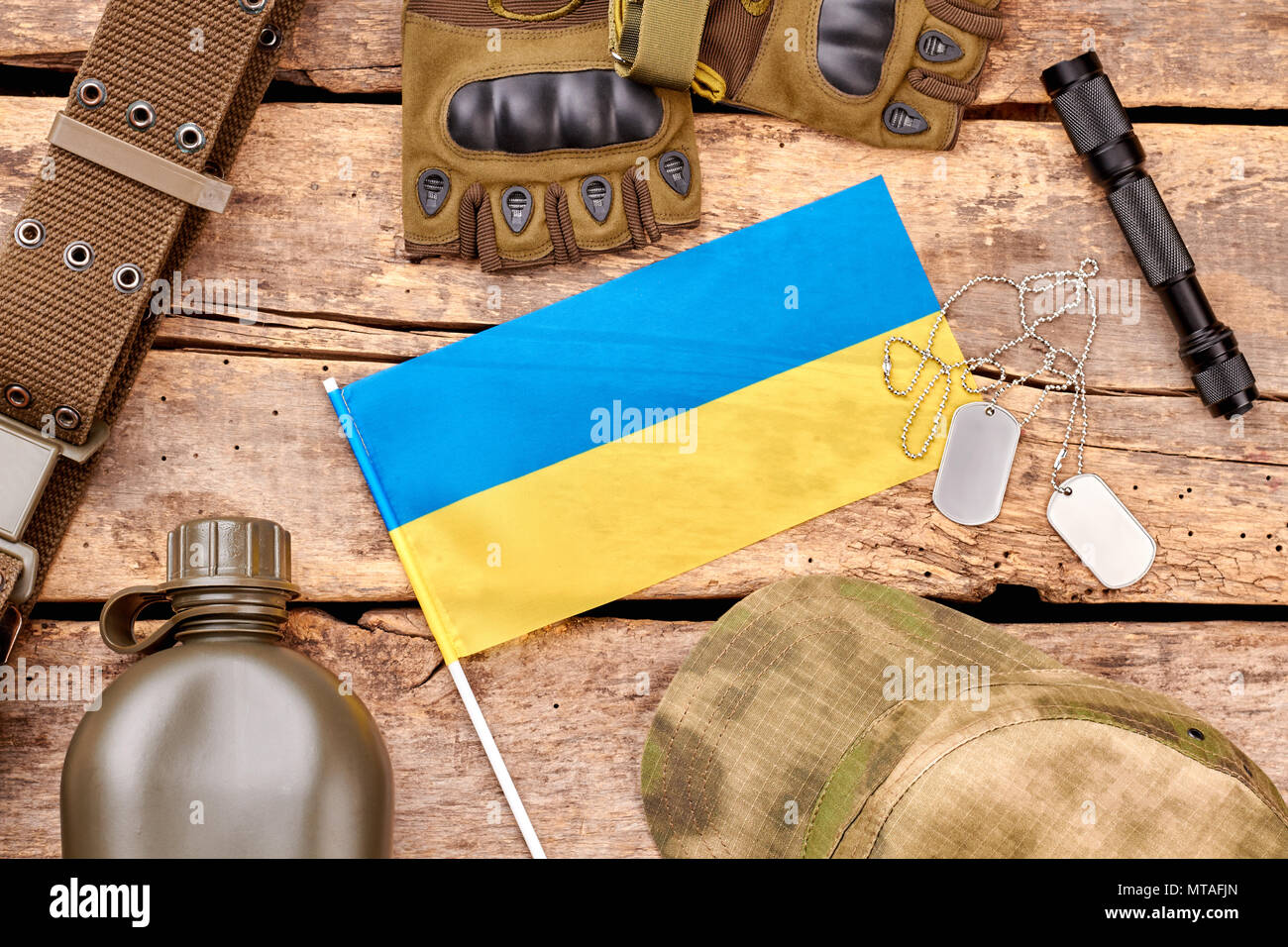 Ukrainian soldier army outfit on wood. Flat lay, top view. Military ...