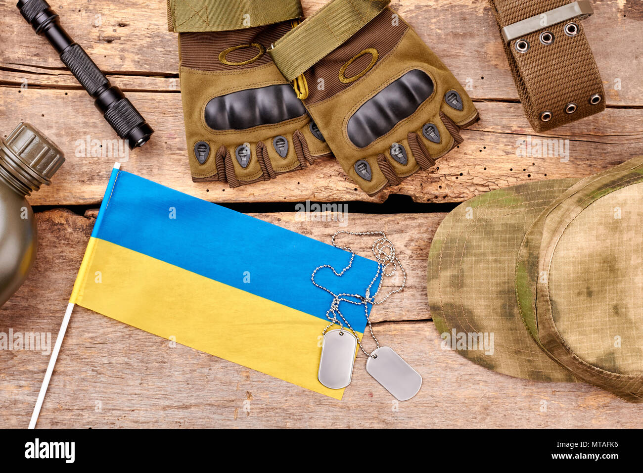 Ukrainian army soldier items arrangement. Top view, flat lay. Wooden ...
