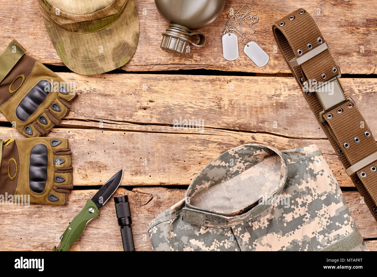 Military attributes items arrangement. Top view, flat lay. Wooden ...