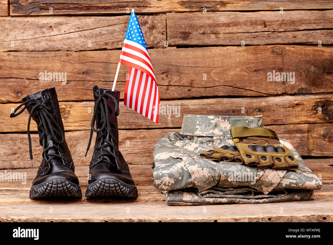 Set of military outfit of us army soldier. Brown wooden desk surface ...