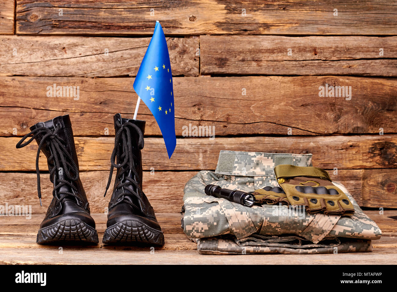 Set of military outfit of european union soldier. Brown wooden desk ...
