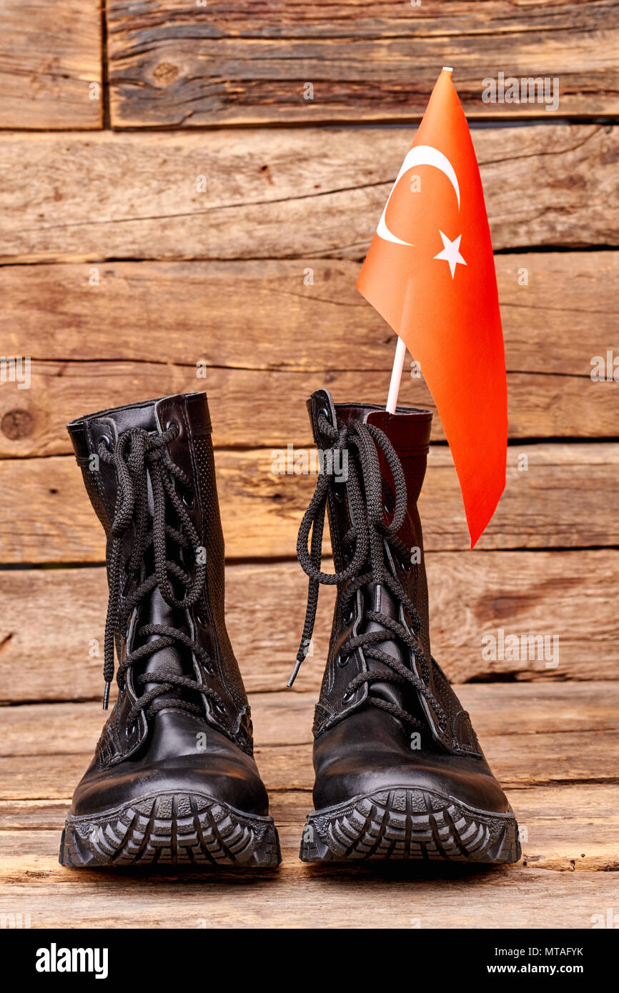Pair of soldier army boots and flag of turkey. Wooden desk background ...
